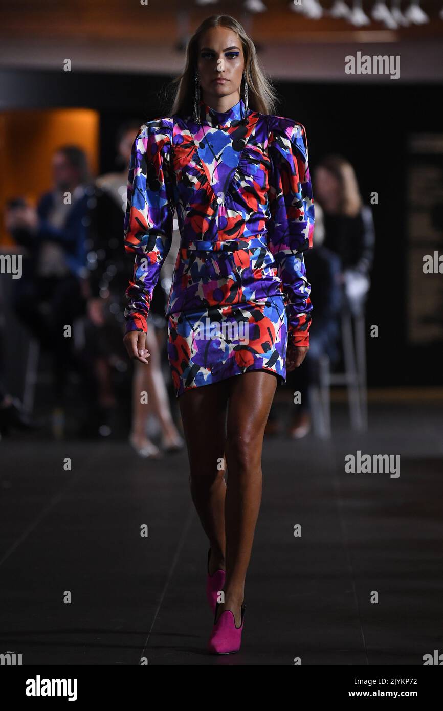 A model walks the runway wearing a design by Rotate during the ...