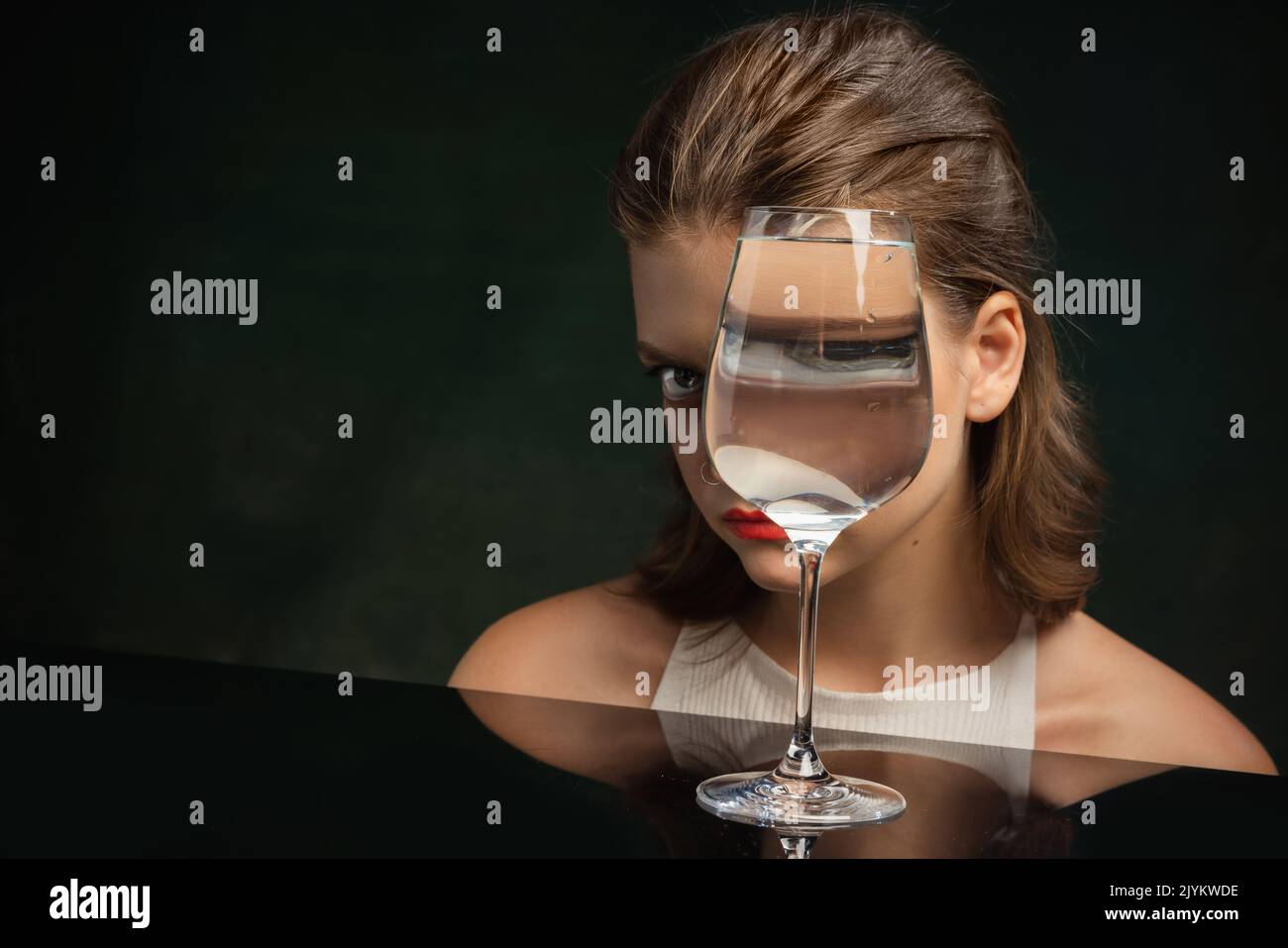 Creative art photography. Stylish girl's face through wine glass over ...