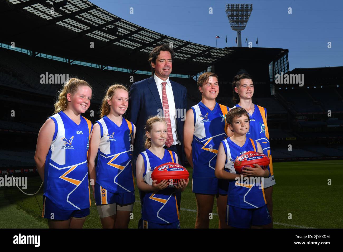 AFL CEO Gillon McLauchlan (centre) poses for a photograph with Macleod ...