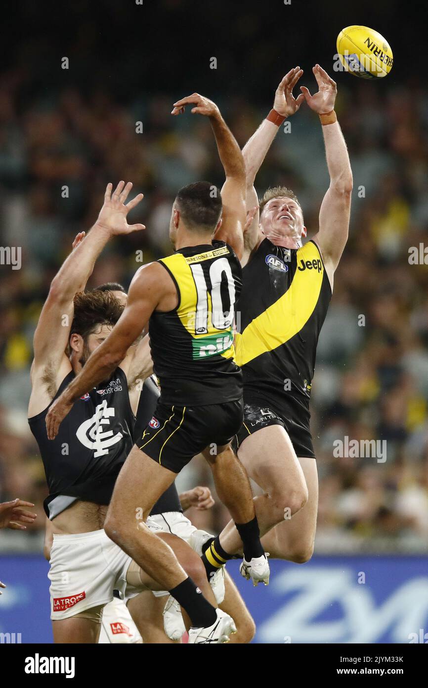 Dylan Grimes of the Tigers (right) attempts to mark the ball during the ...