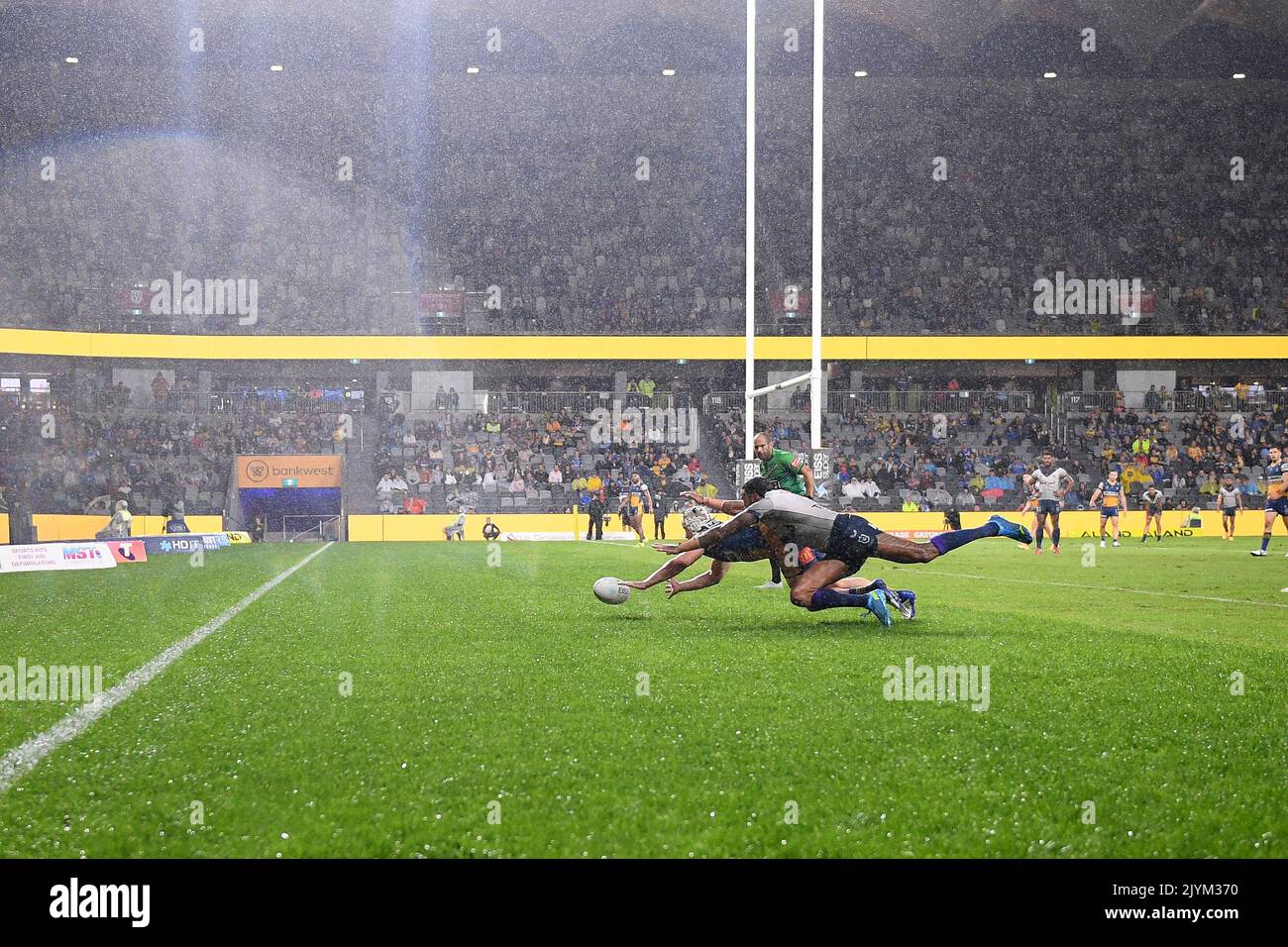 Reed Mahoney of the Eels and Josh Addo-Carr of the Storm dive for the ...