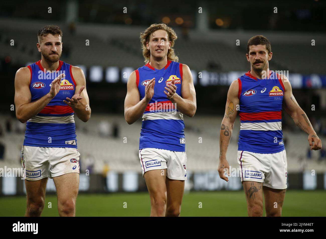 Marcus Bontempelli, Aaron Naughton and Tom Liberatore of the Bulldogs ...
