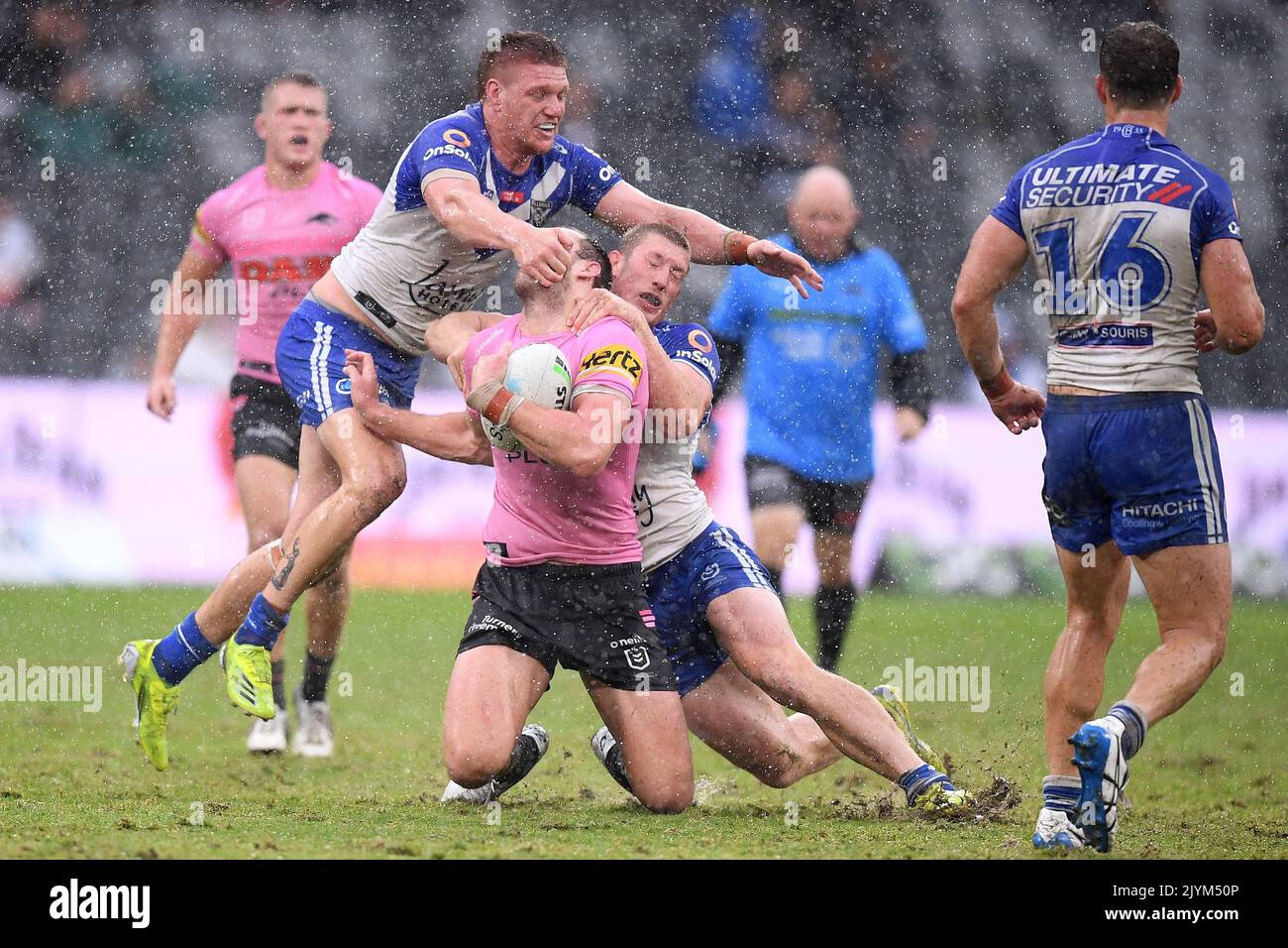 Issah Yeo of the Panthers is tackled by Jack Hetherington (right) and ...