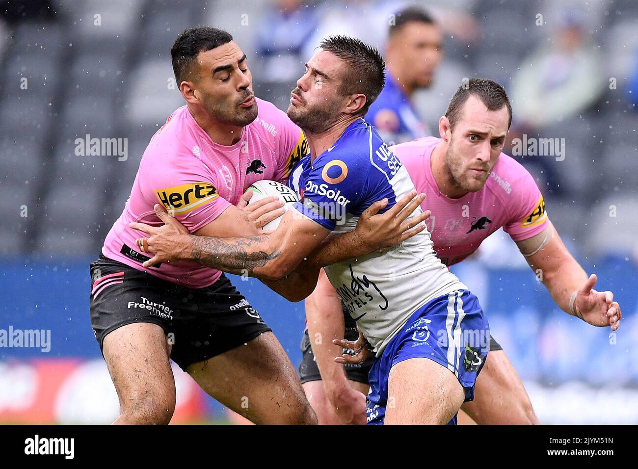 Corey Allan of the Bulldogs is tackled by Tyrone May of the Panthers ...