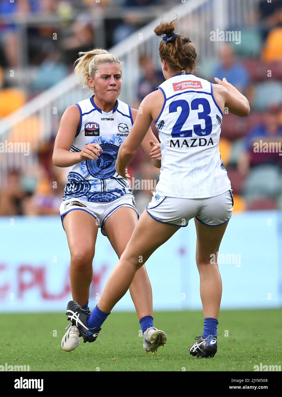 Daisy Bateman (left) of the Kangaroos celebrates kicking a goal with ...