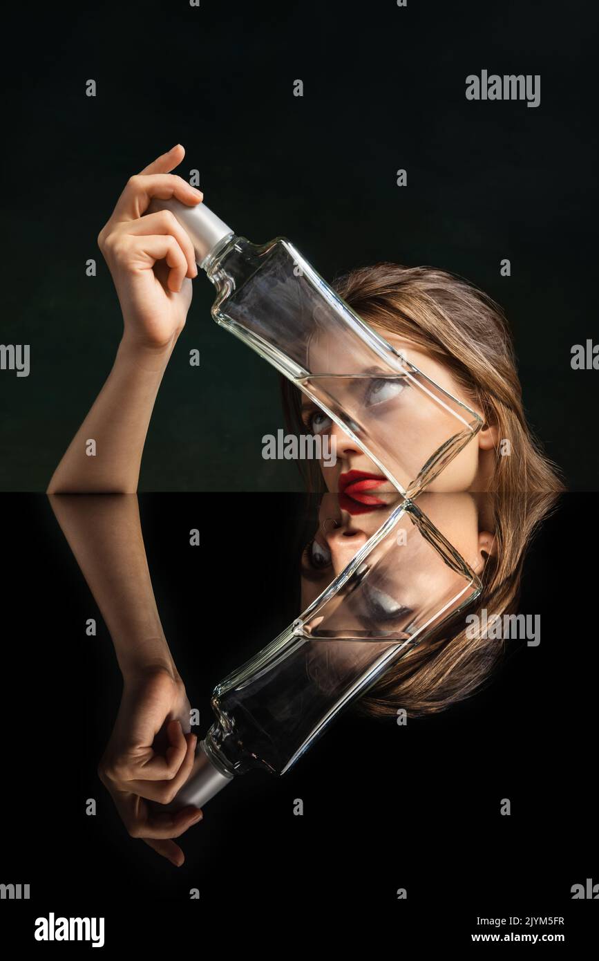 Surreal art photography. Young girl's face through empty glass bottle ...