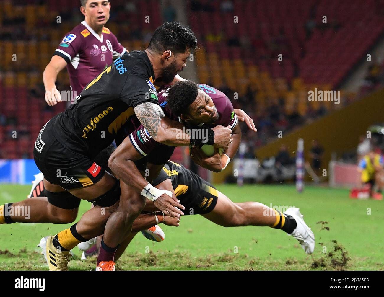 Ilaisa Droasese of the Reds (centre) is denied a try by Henry Taefu of ...