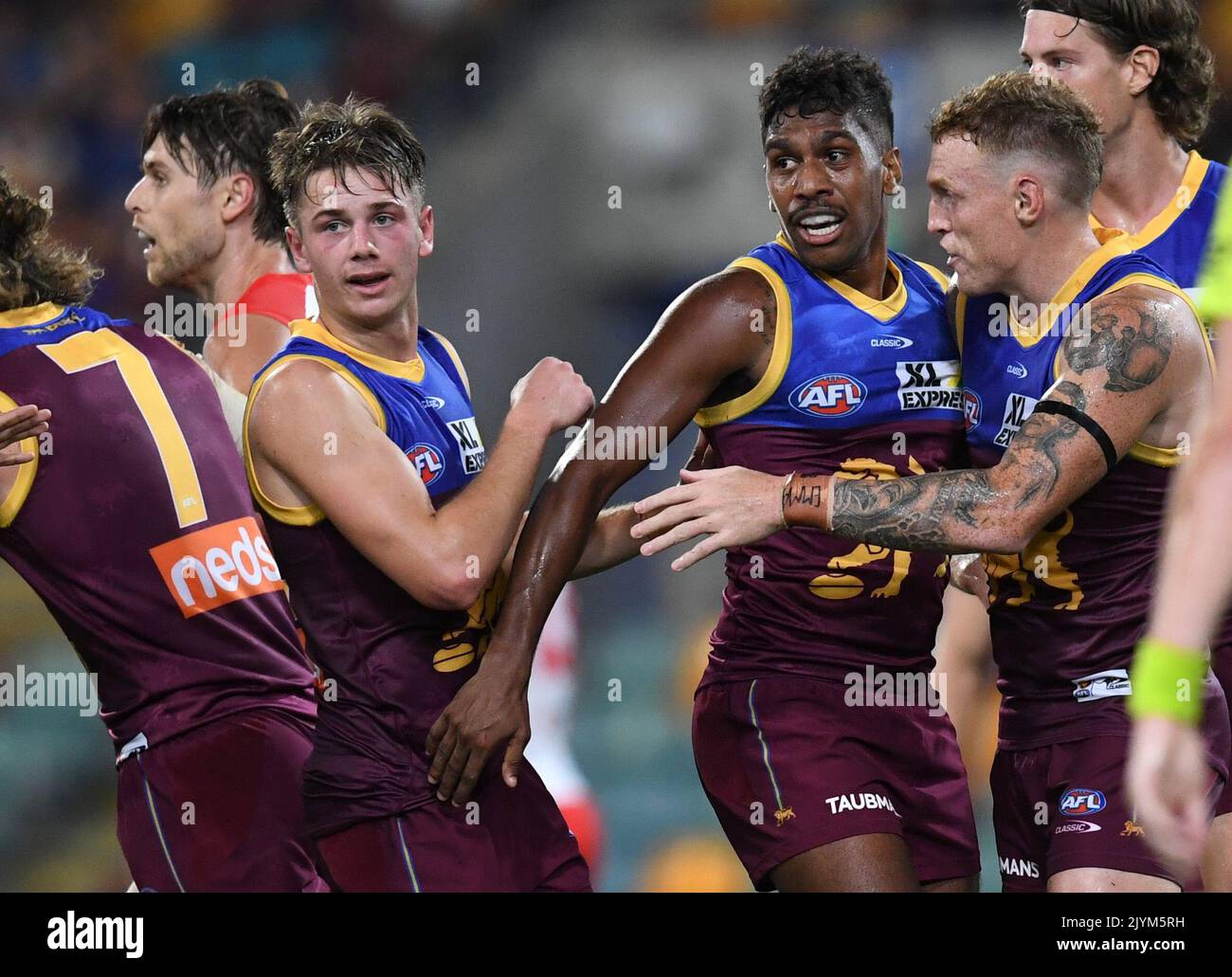 Keidean Coleman (centre) of the Lions celebrates kicking a goal with ...