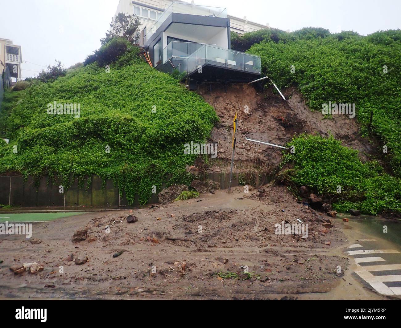 A house is seen after a landslip took out some of its foundations ...