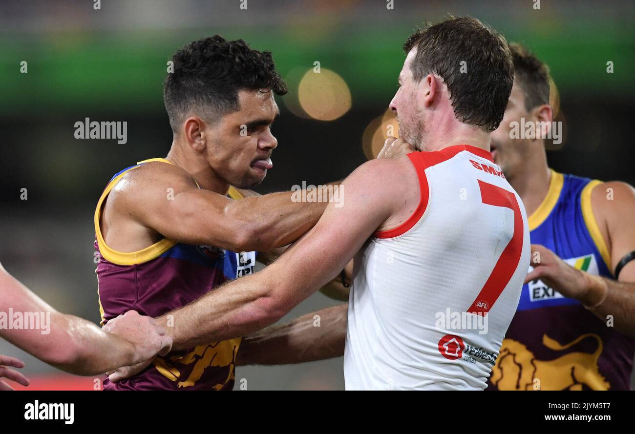 Charlie Cameron (left) of the Lions shoves Harry Cunningham (right) of ...