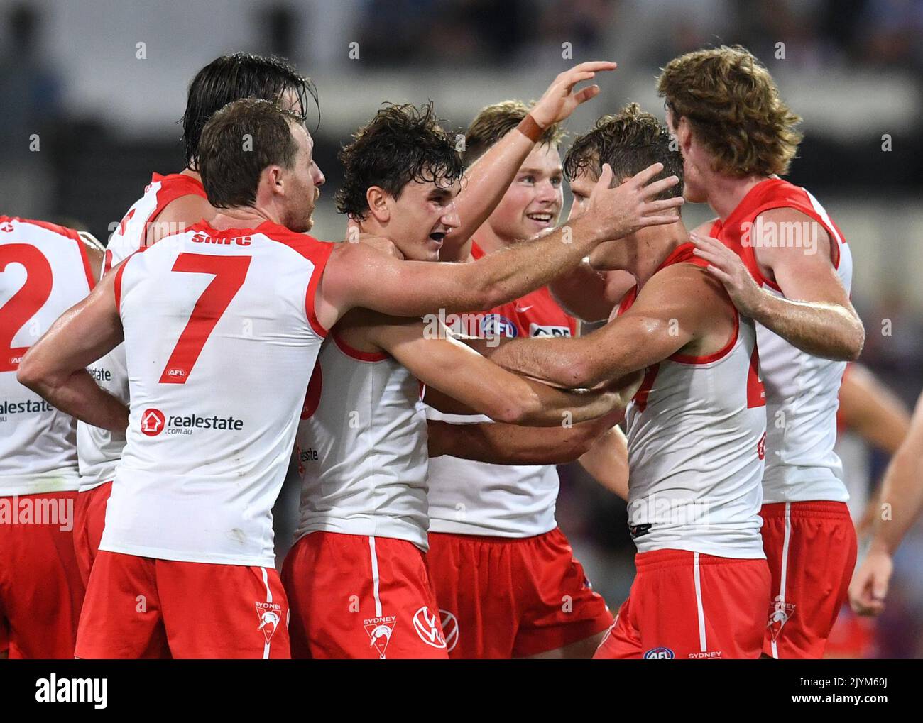 Sam Wicks (centre) of the Swans celebrates kicking a goal with team ...