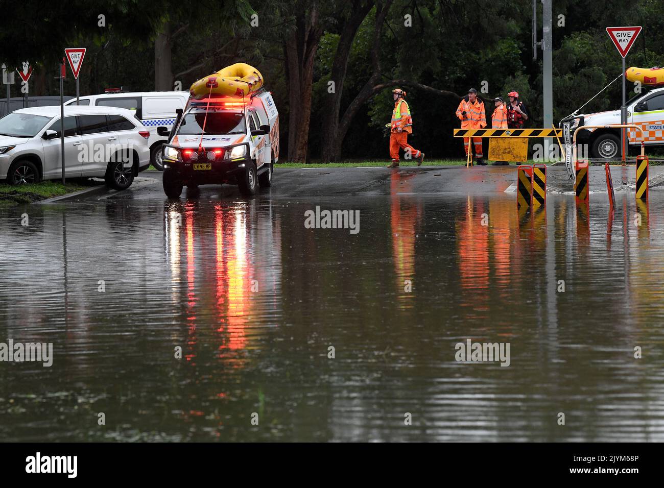 SES crews are seen as floodwater submerges the road on the corner of ...