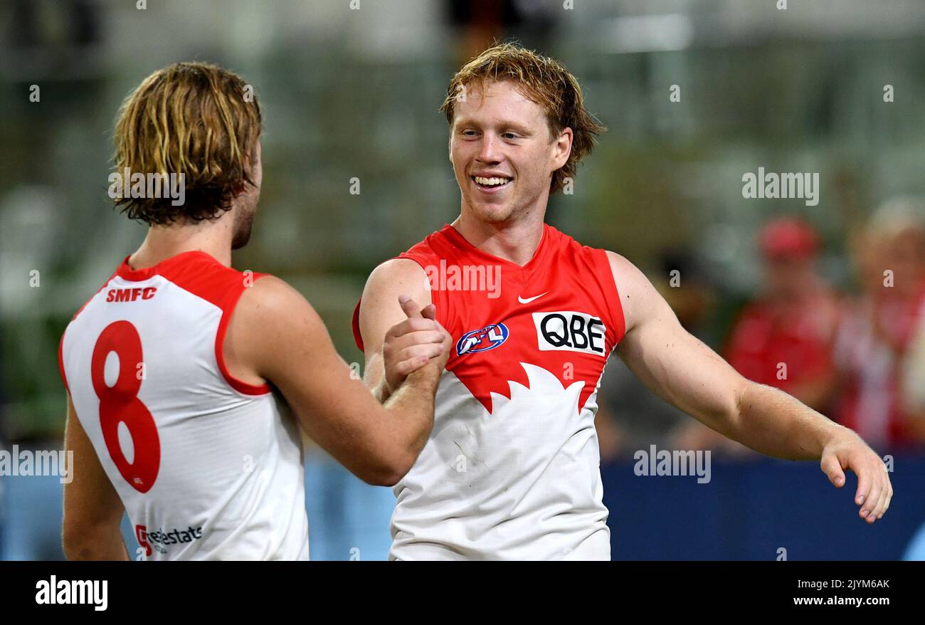 Callum Mills (right) of the Swans celebrates winning with James ...