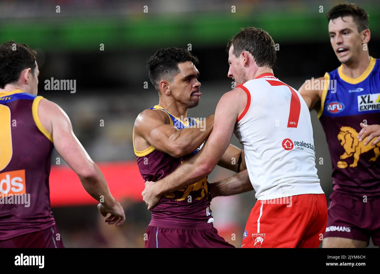 Charlie Cameron (left) of the Lions shoves Harry Cunningham (right) of ...