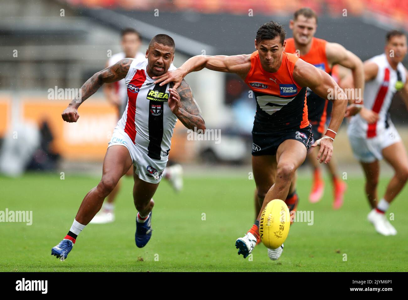 Bradley Hill of the Saints contests the ball with Isaac Cumming of the ...