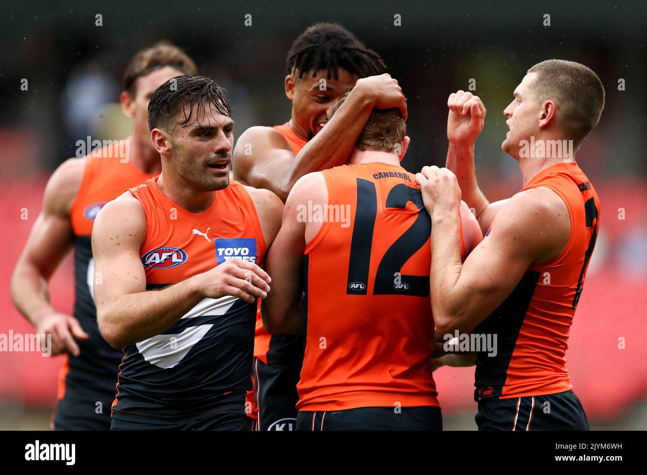 Tom Green of the Giants celebrates kicking a goal with team mates ...