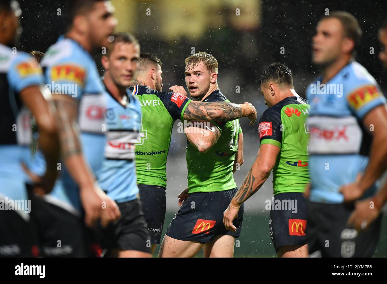 Hudson Young of the Raiders (centre) celebrates scoring a try during ...