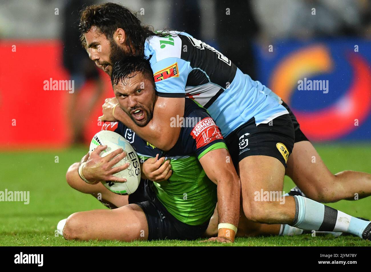 Toby Rudolf of the Sharks tackles Jordan Rapana of the Raiders during ...