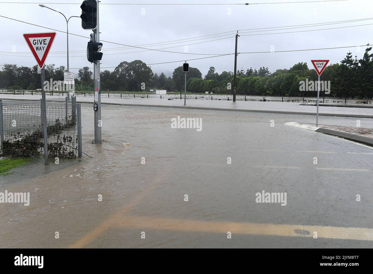 Flash flooding cuts a road at Mudgeeraba on the Gold Coast, Tuesday ...