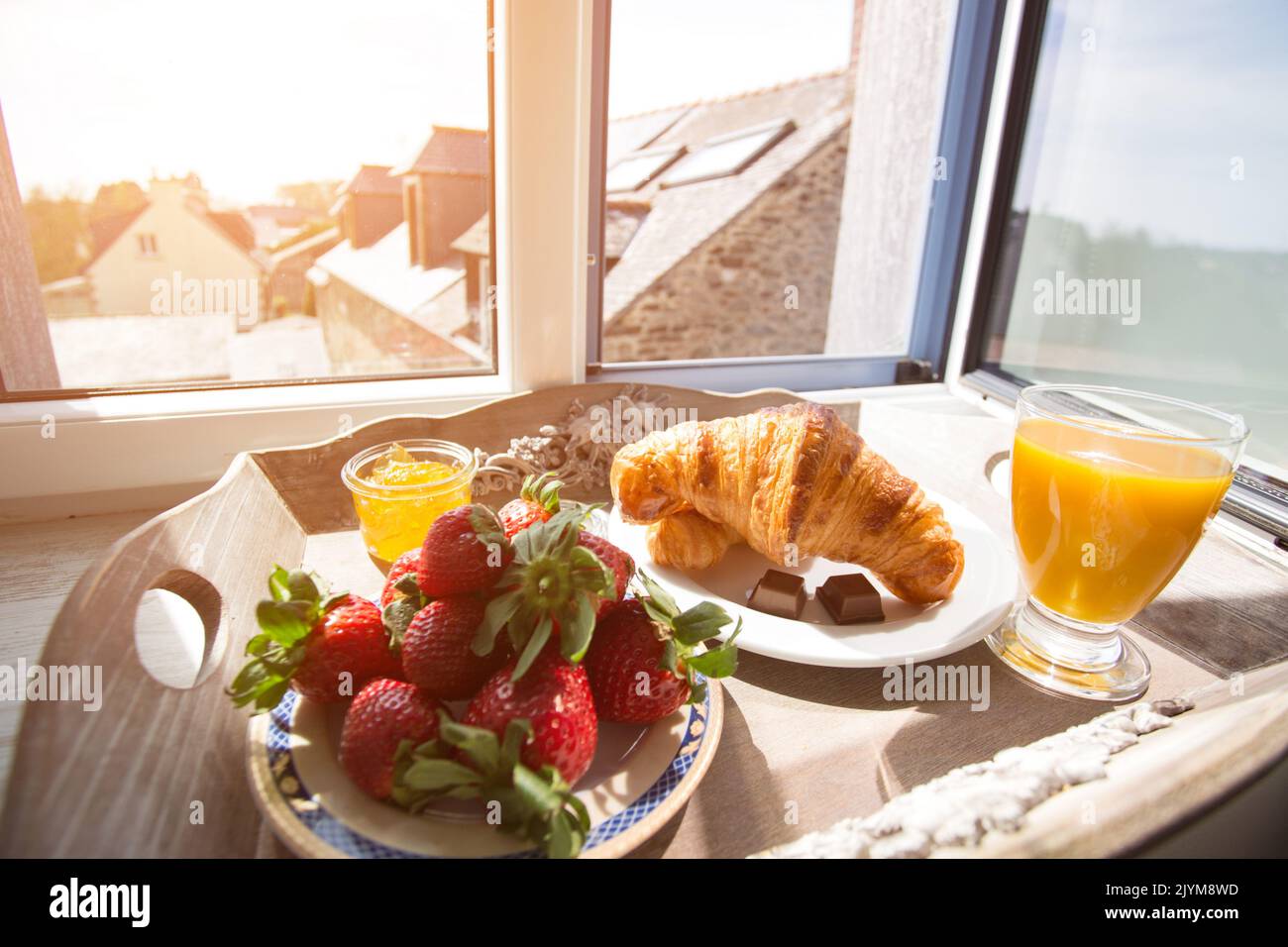 delicious French breakfast on a tray with a view of the castle Stock ...