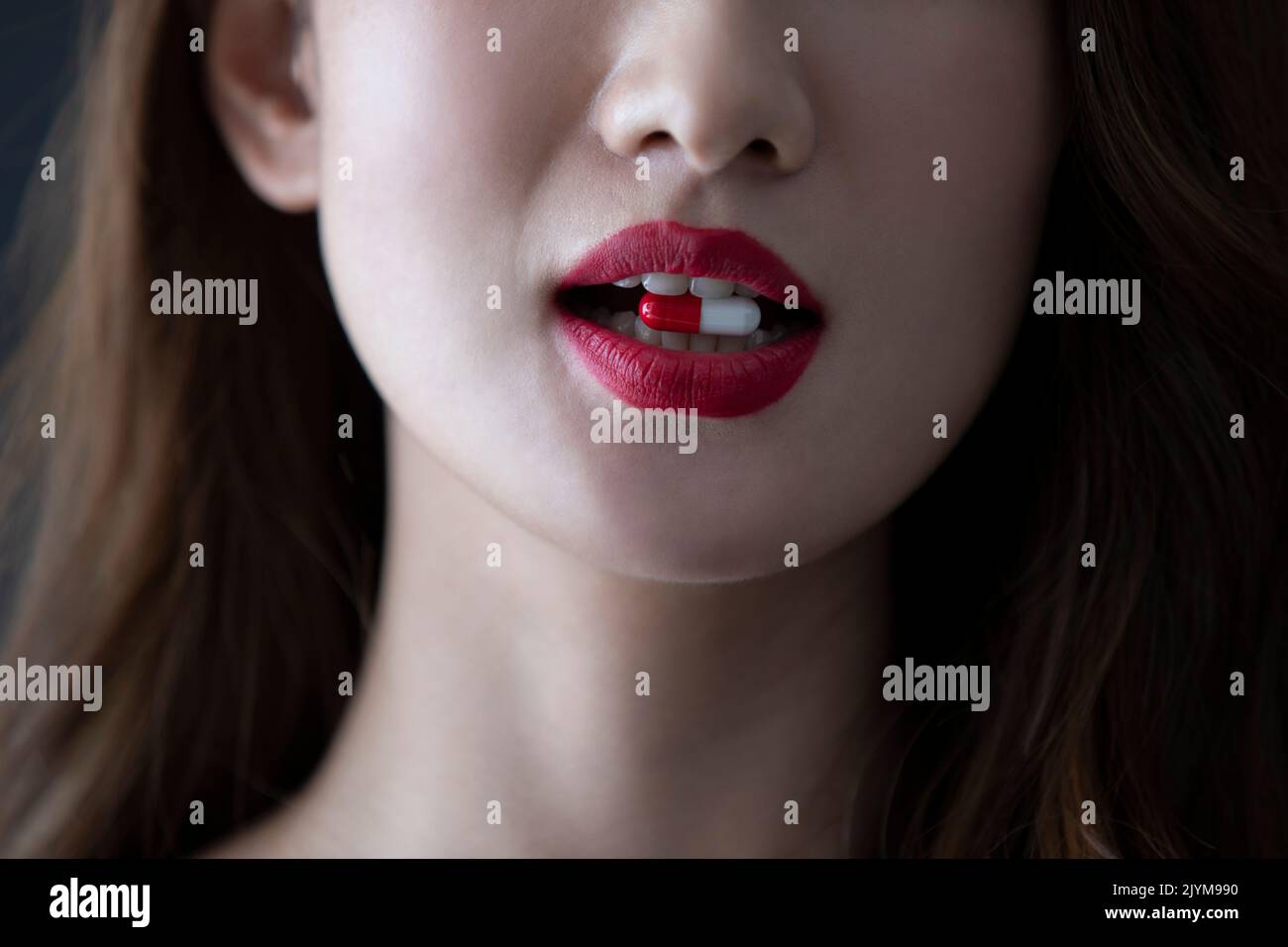 Woman taking pill red lips hi-res stock photography and images - Alamy