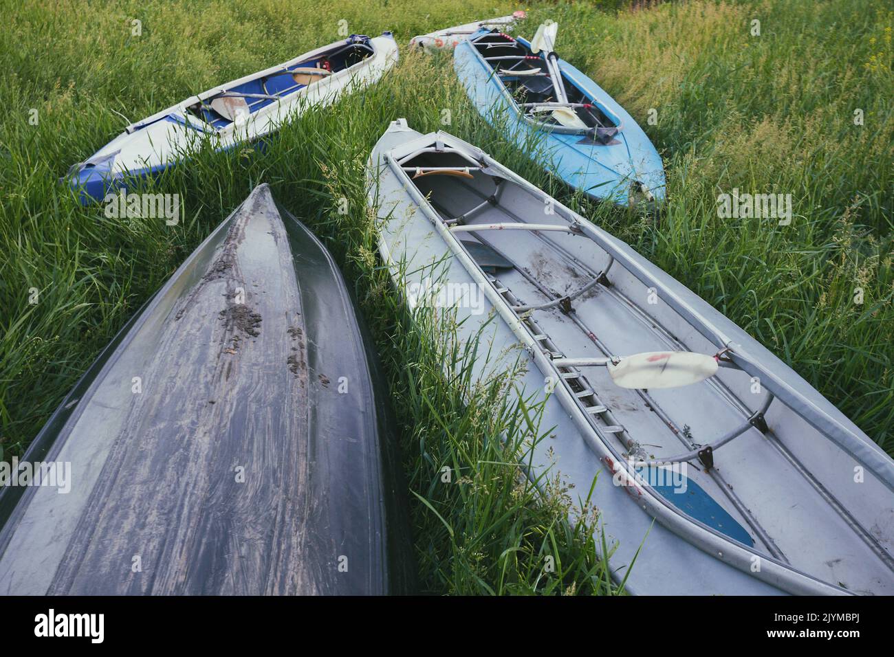 summer and active sport. kayaks lie on the grass Stock Photo - Alamy