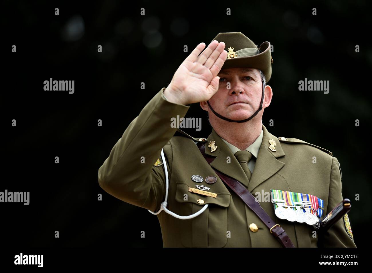 Australian Defence Force (ADF) Major Dave McGarry salutes during a ...