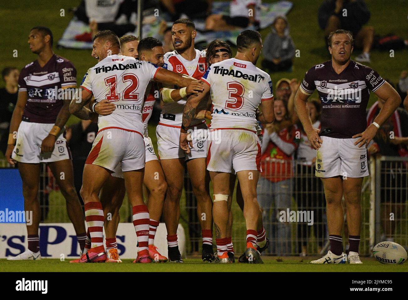The Dragons celebrate after Bryden Williame scores a try during the ...