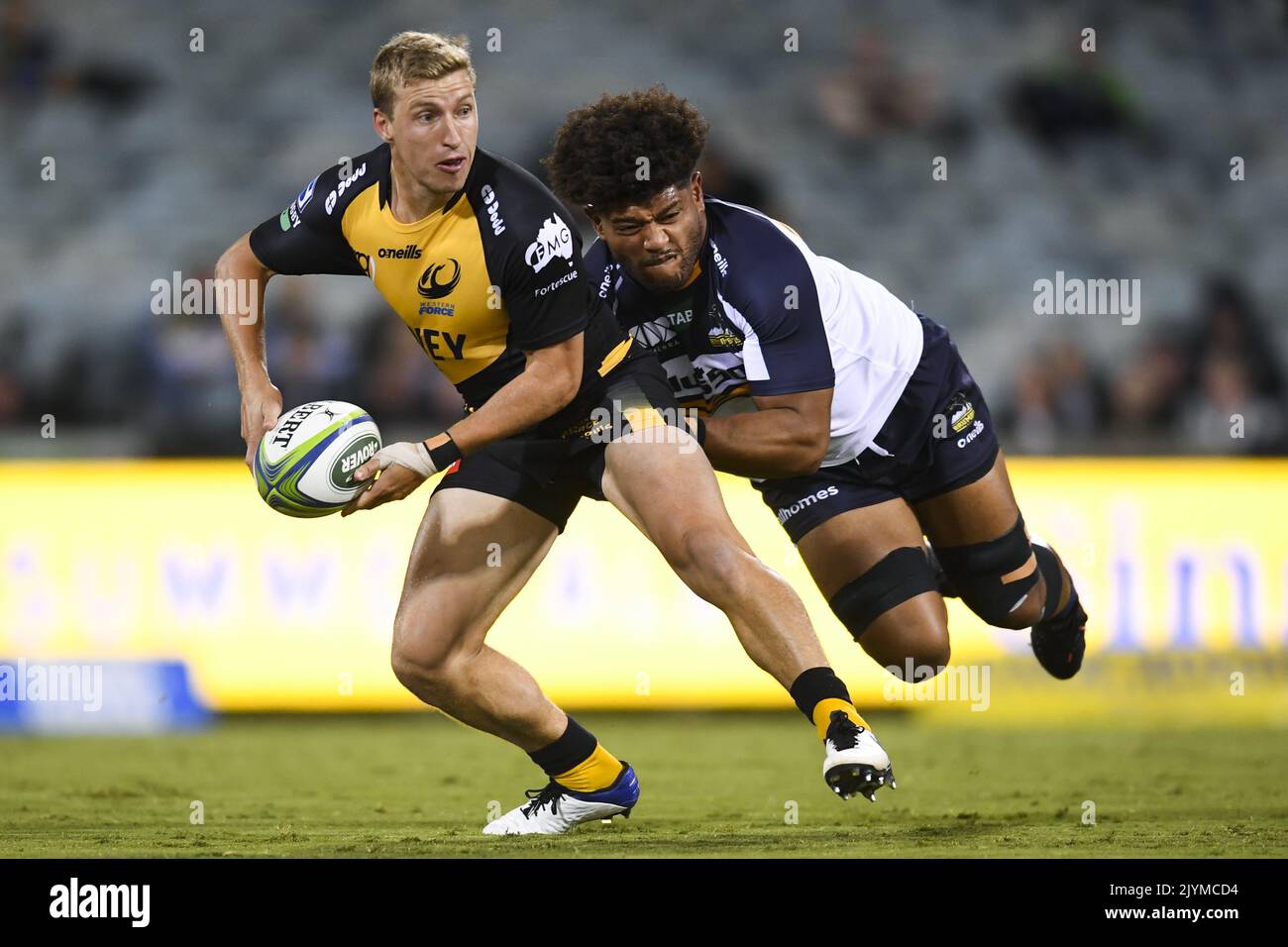 Jake McIntyre of the Western Force (left) is tackled by Robbie Valetini ...