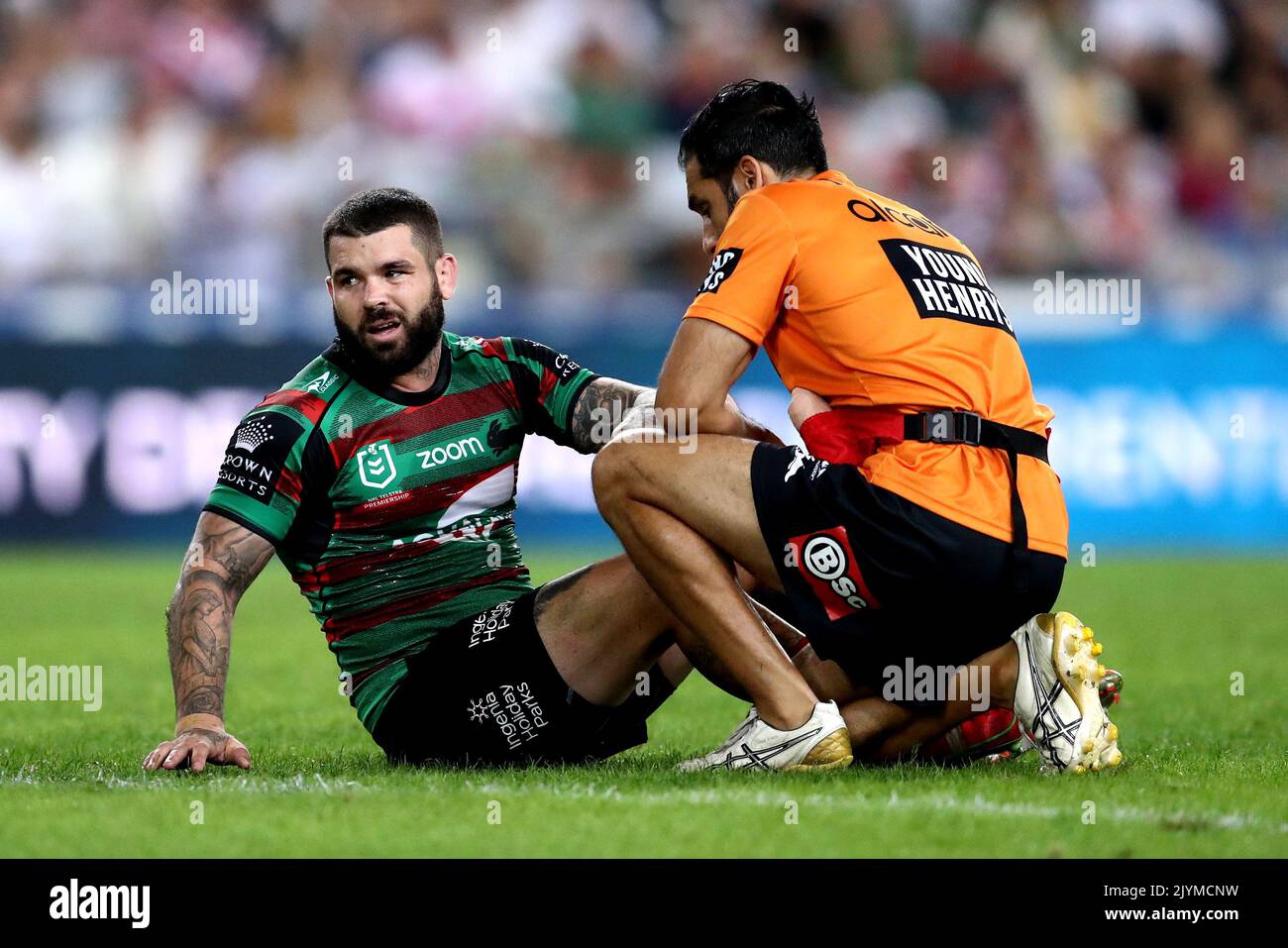 Adam Reynolds of the Rabbitohs receives attention from a trainer during ...