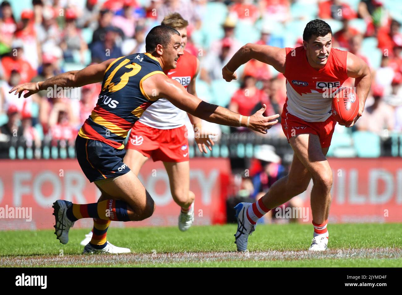 Tom McCartin of the Swans and Taylor Walker of the Crows during the ...