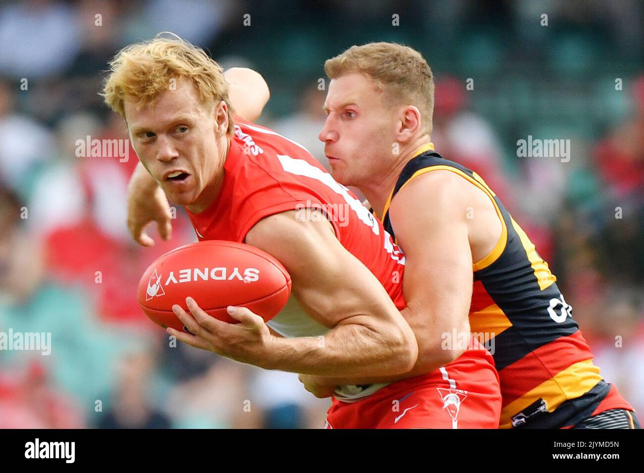Rory Laird of the Crows tackles Callum Mills of the Swans during the ...