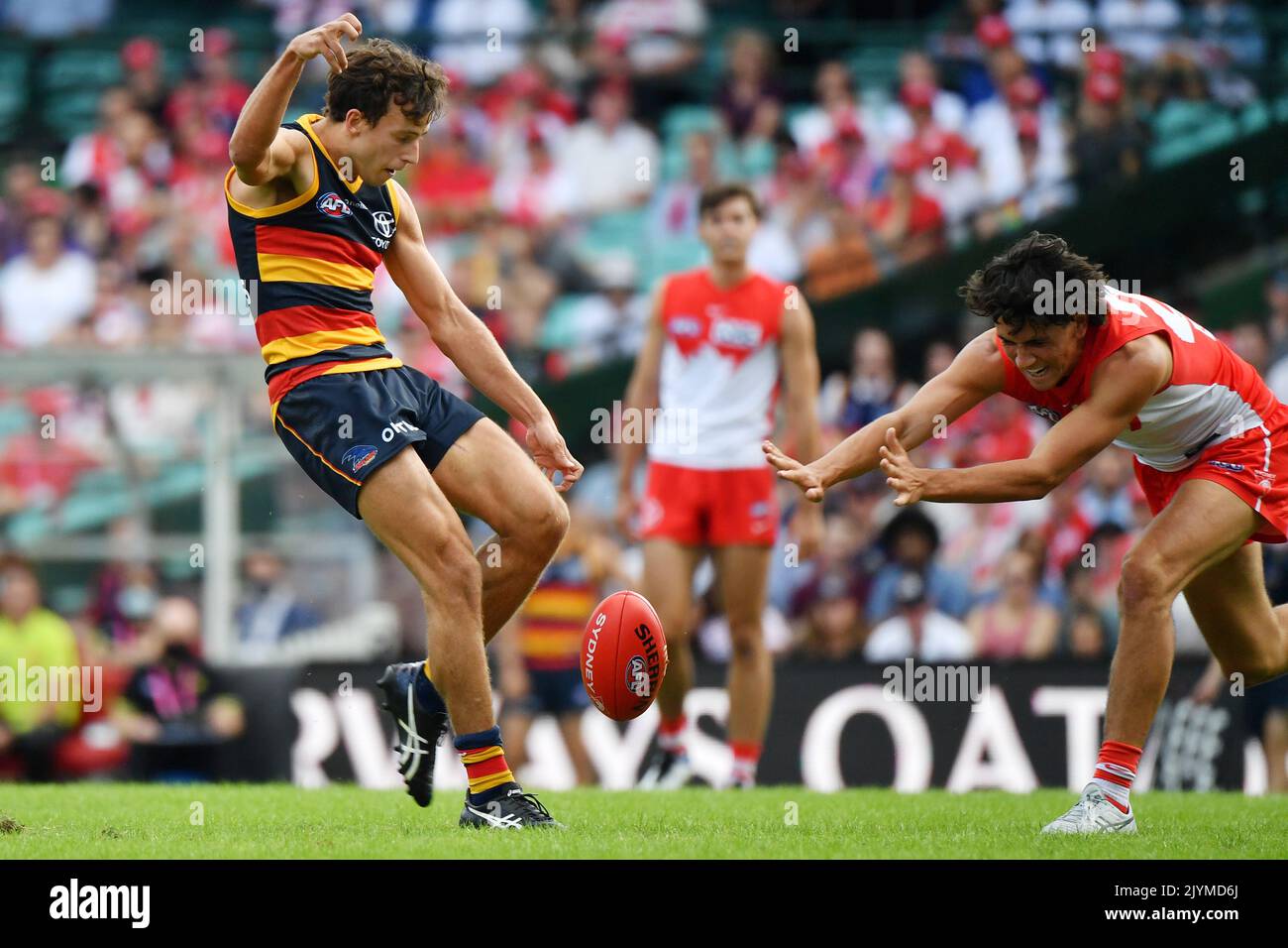 Justin McInerney of the Swans shuts down a kick from Will Hamill of the ...