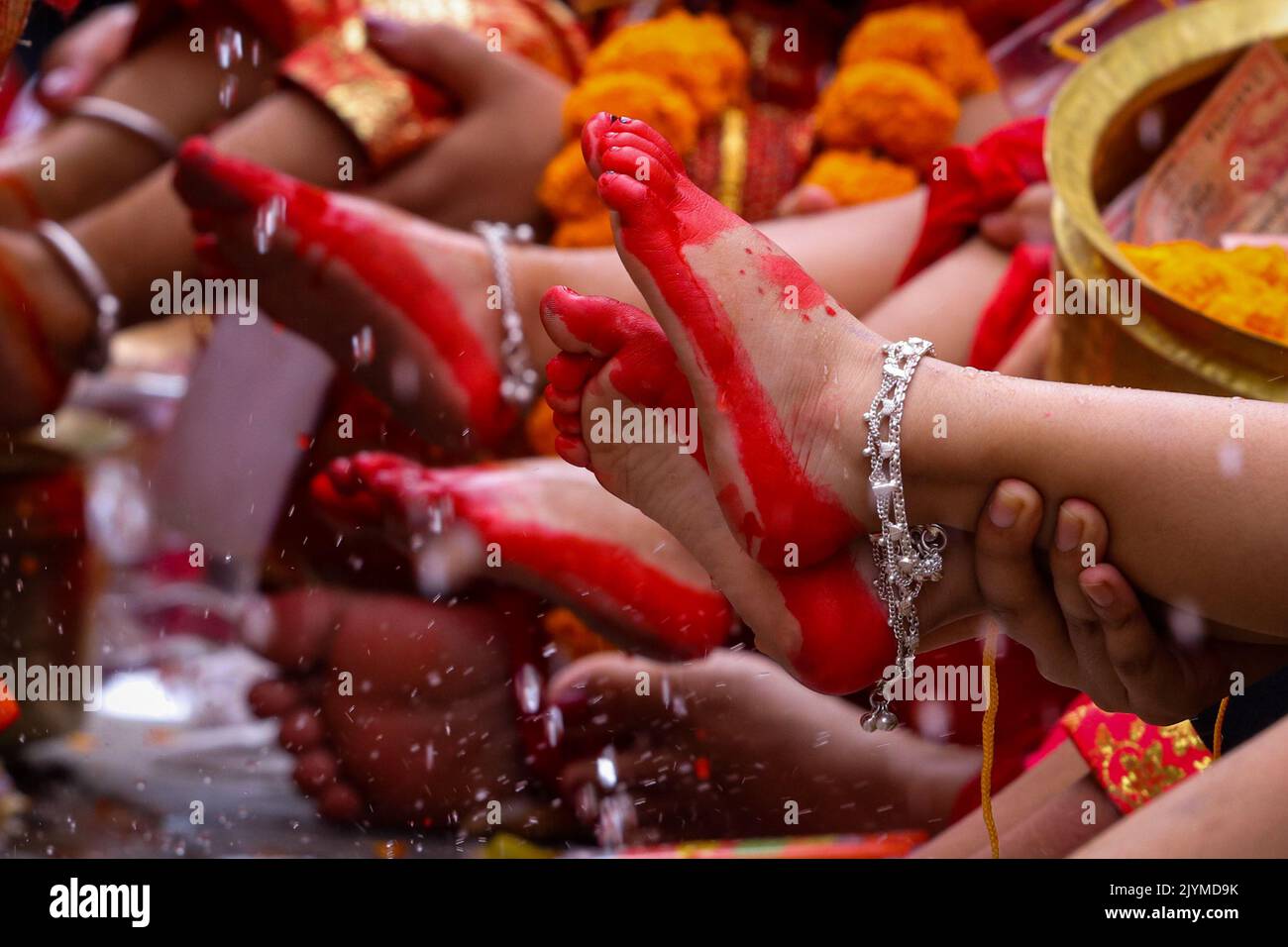 Children dressed as living goddess "Kumari" have their feet washed with ...