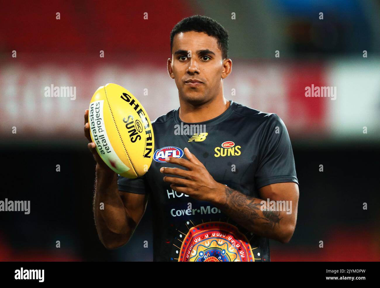 Touk Miller of the Suns warms up before the Round 2 AFL match between ...