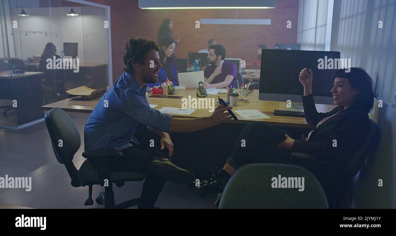 People working at Office workplace interior at night. Interior of busy ...