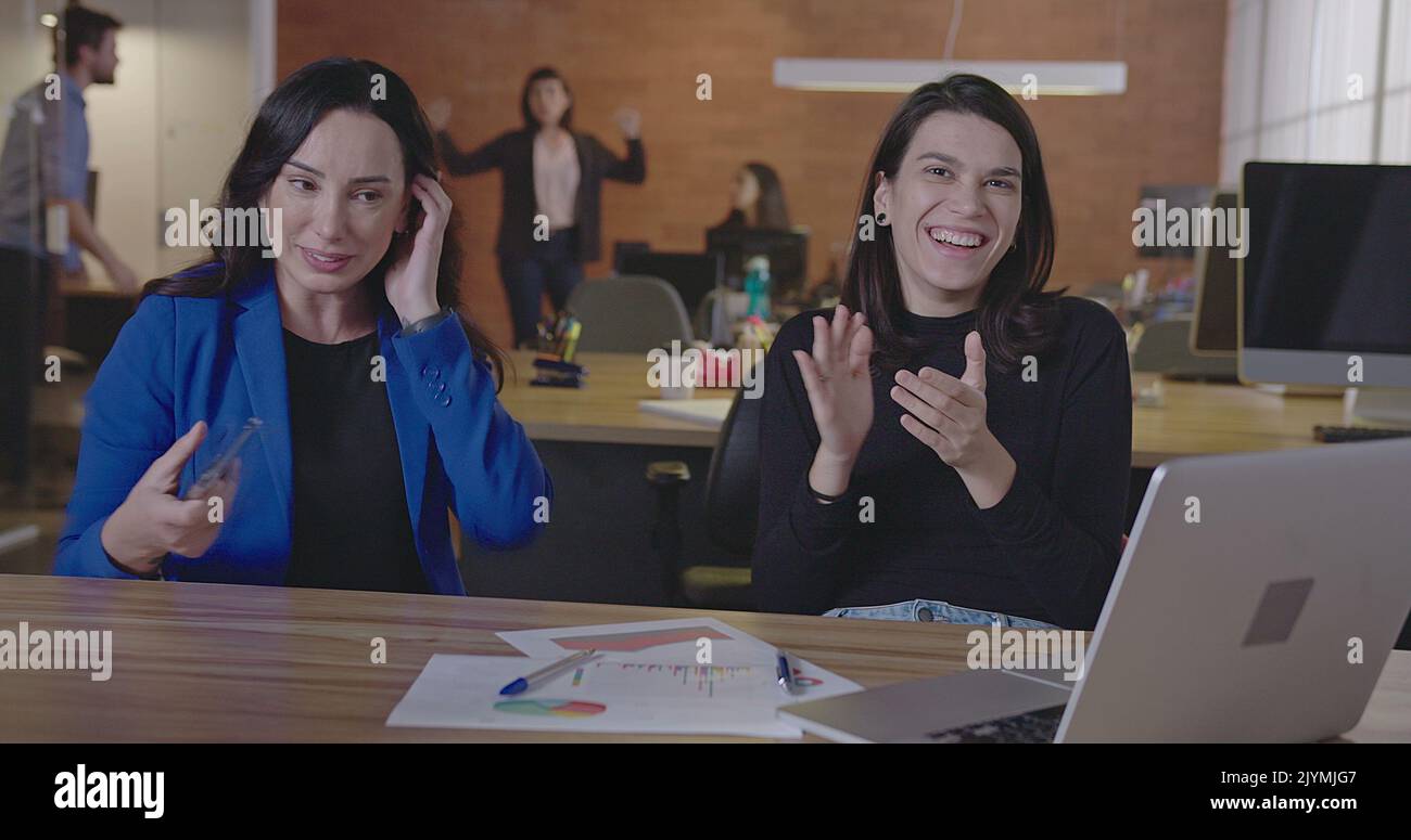 Group of office workers clapping and smiling. Happy People celebrating success at workplace. POV ...