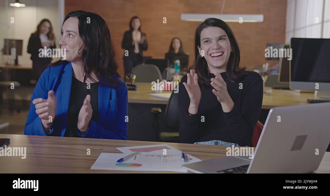 Group of office workers clapping and smiling. Happy People celebrating success at workplace. POV ...