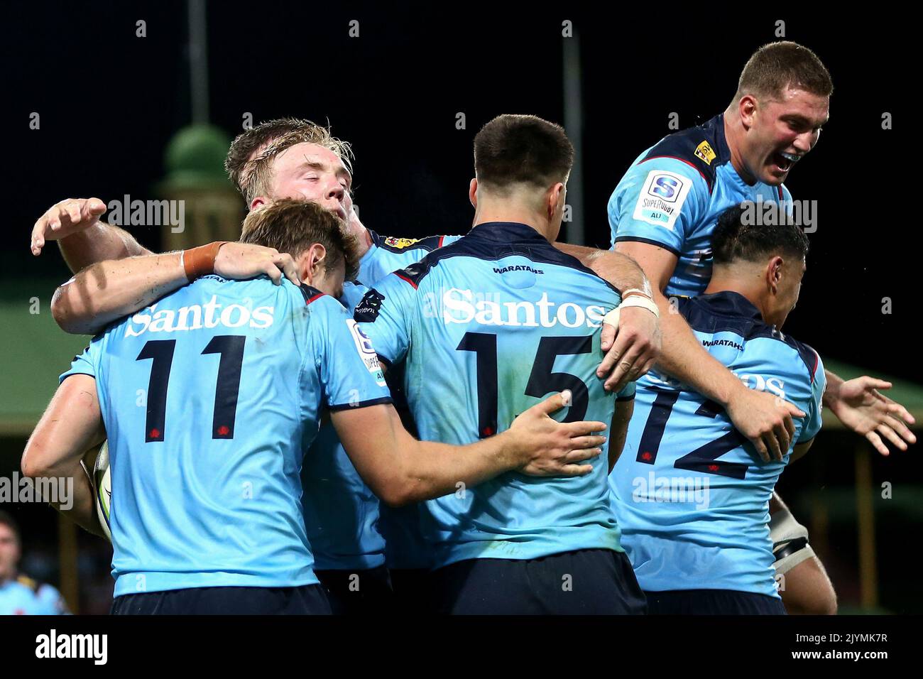 James Ramm of the Waratahs celebrates scoring a try with team mates ...