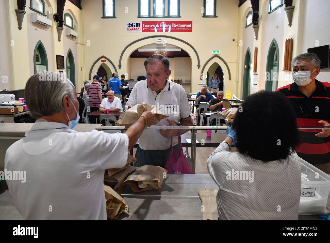 Volunteers hand out free meals during an Easter Sunday roast at the Rev ...