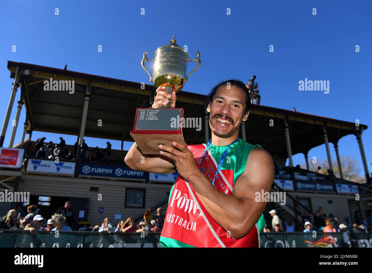 Edward Ward holds a trophy after winning the Powercor Stawell Gift 120m ...