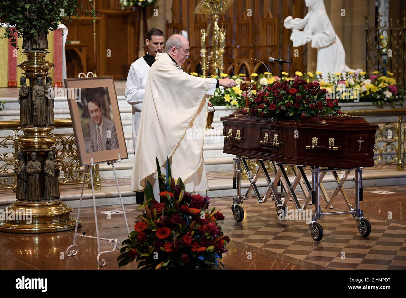 Father Brian Lucas blesses the coffin during the Requiem Funeral Mass ...