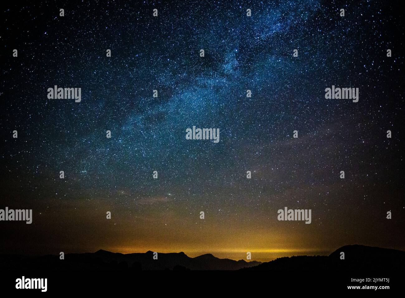 Starry night and light pollution on the mountain ridge of Lure ...