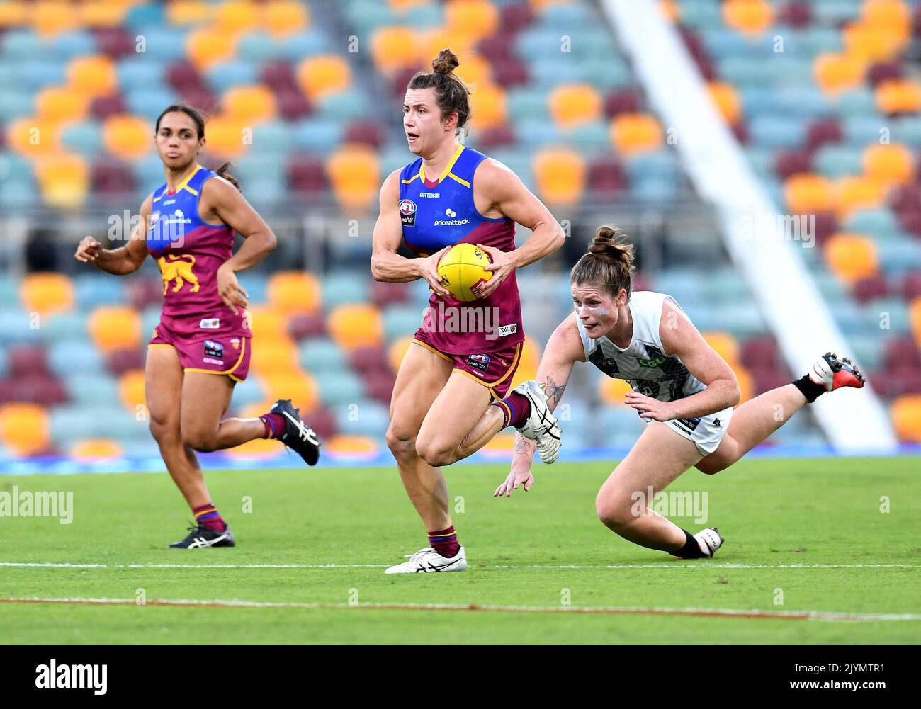 Catherine Svarc of the Lions (centre) makes a break as she is chased by ...