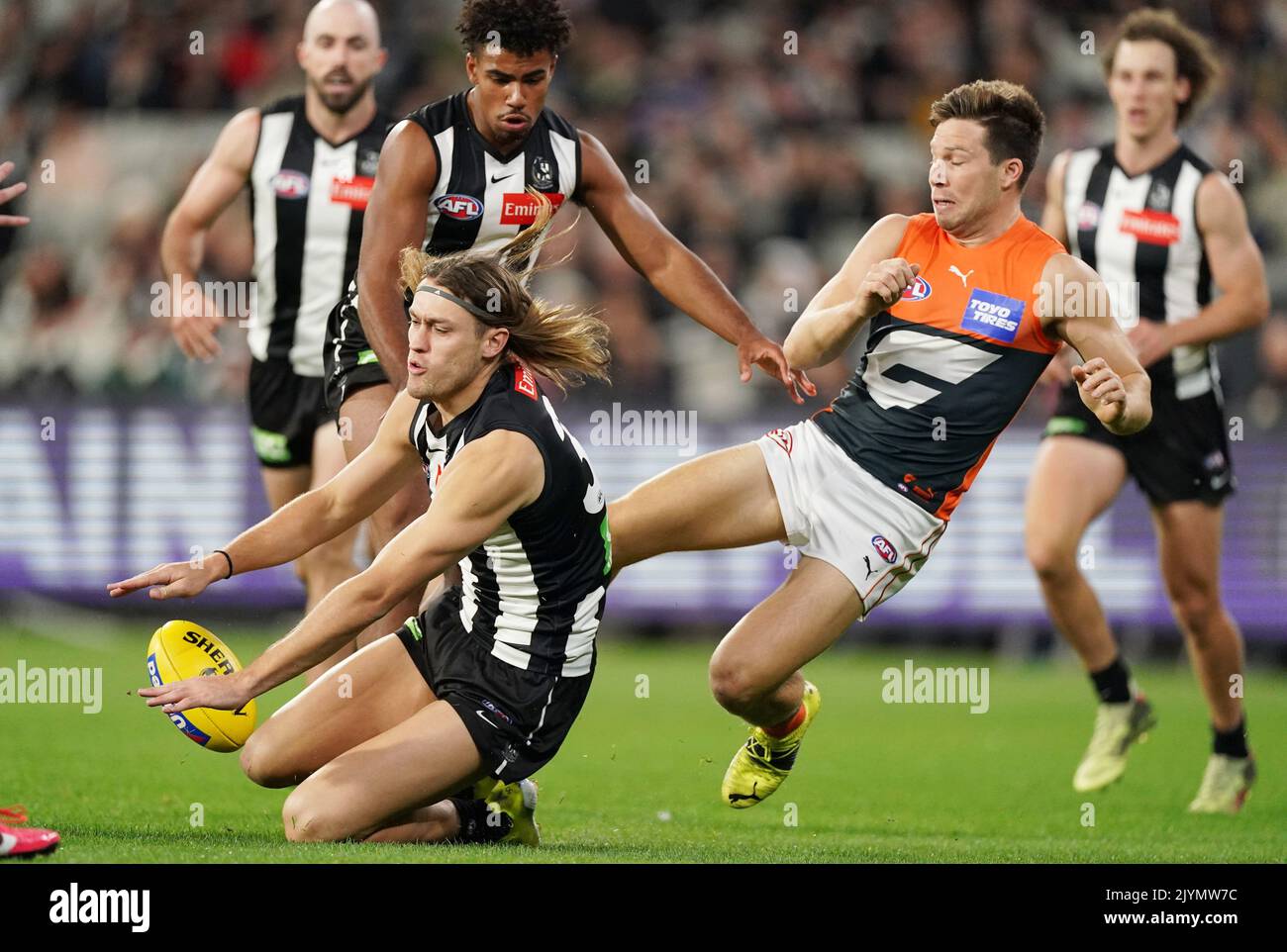 Toby Greene of the Giants has his kick blocked by Darcy Moore of the ...