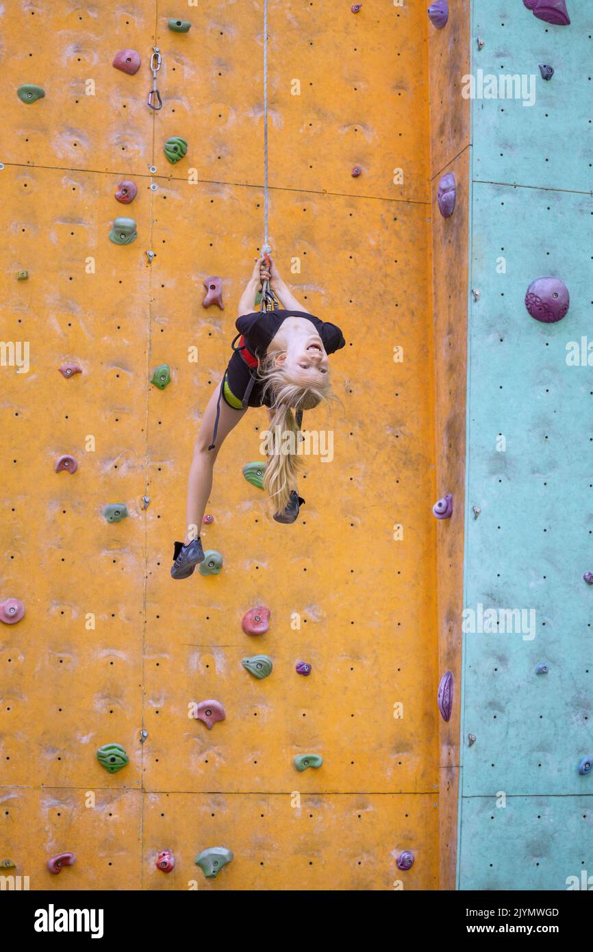 sport. bouldering, little fun girl climbing up the wall Stock Photo - Alamy