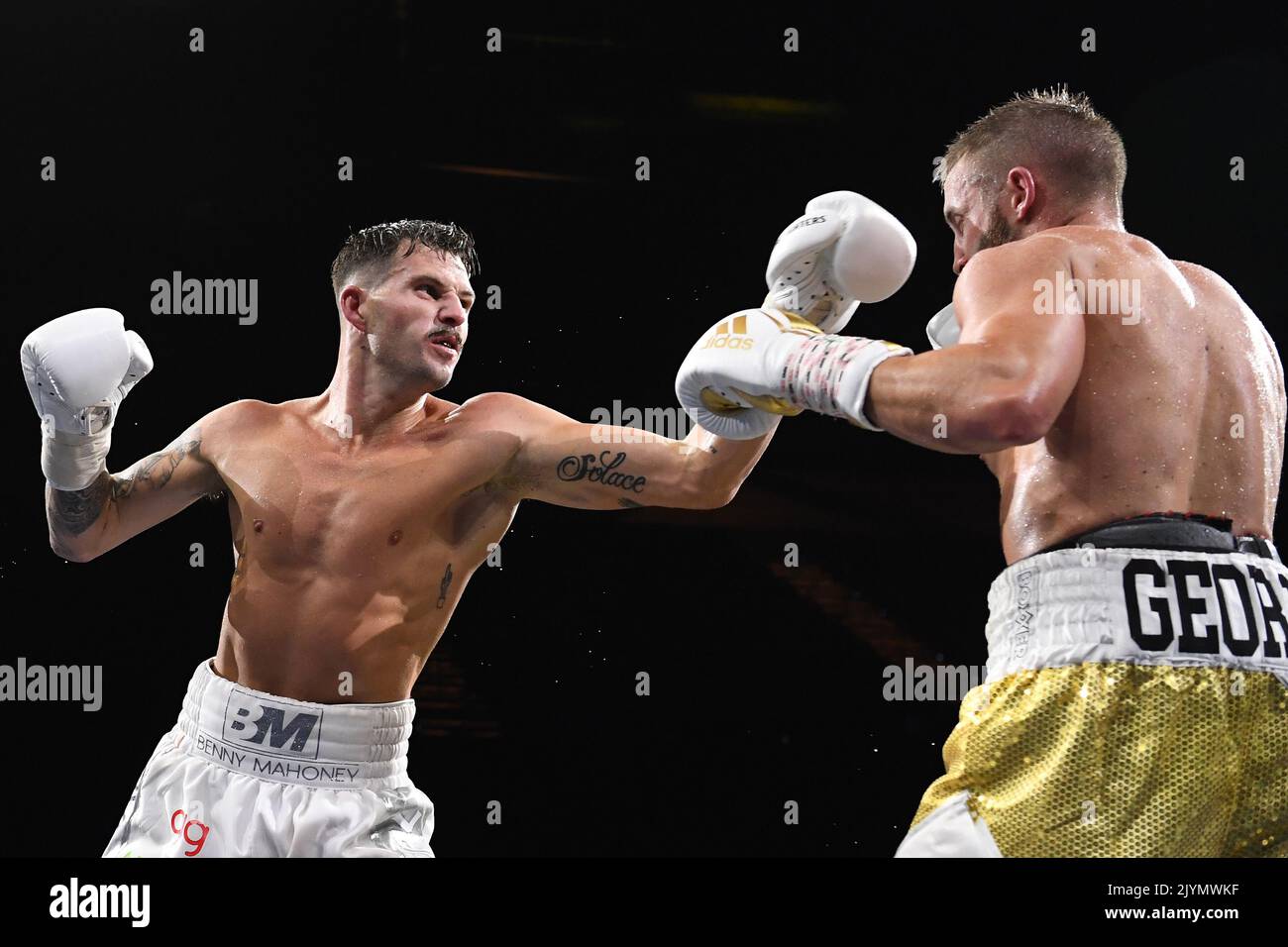 Ben Mahoney (left) lands a punch on Kris George (right) during the ...