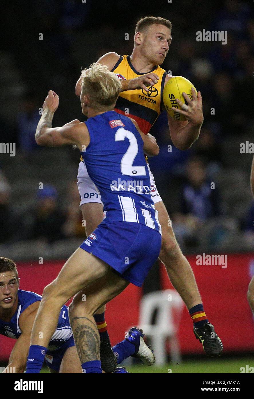 Rory Laird of the Crows is tackled by Jaidyn Stephenson of the ...