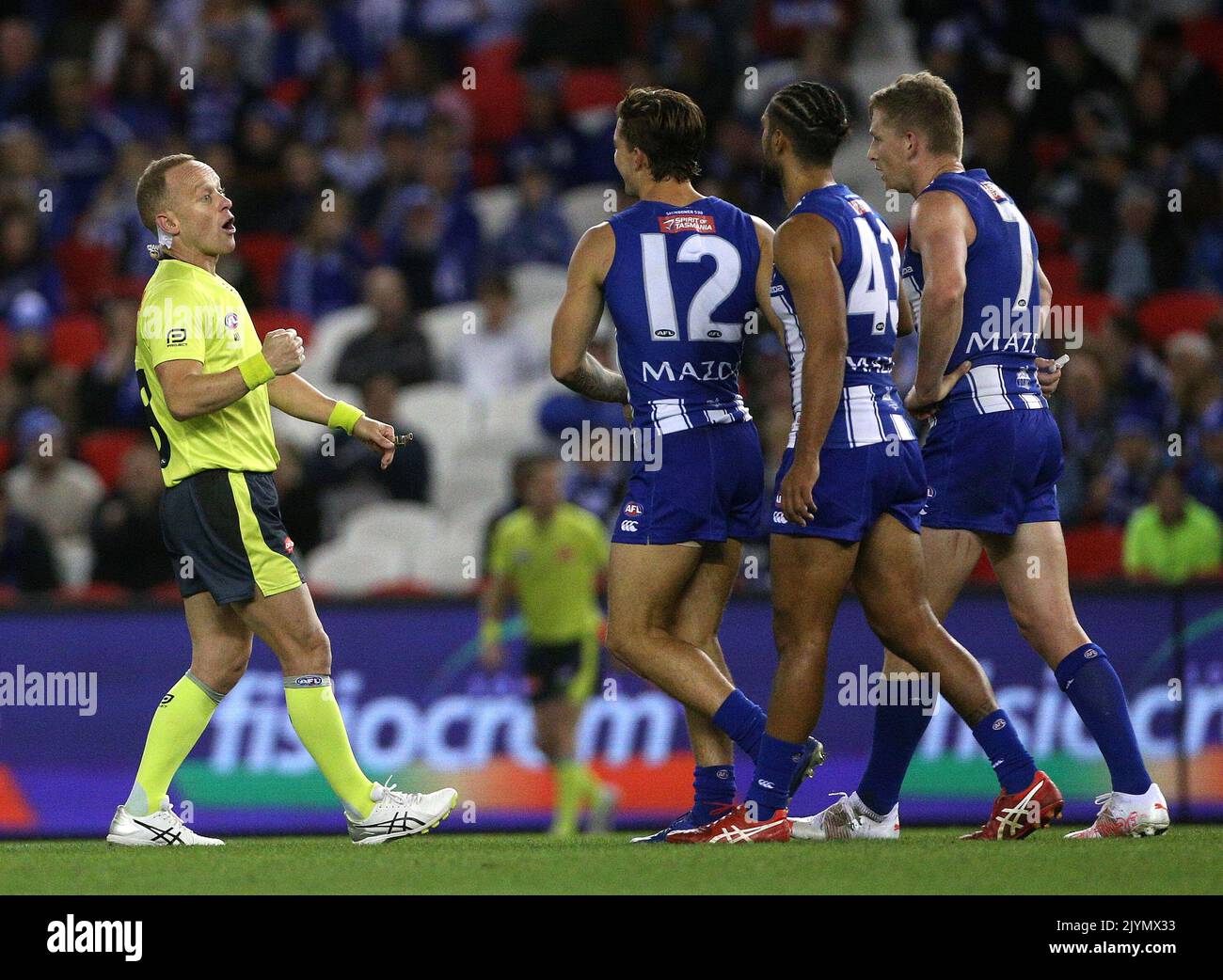 Umpire Ray Chamberlain speaks with Jy Simpkin of the Kangaroos during ...
