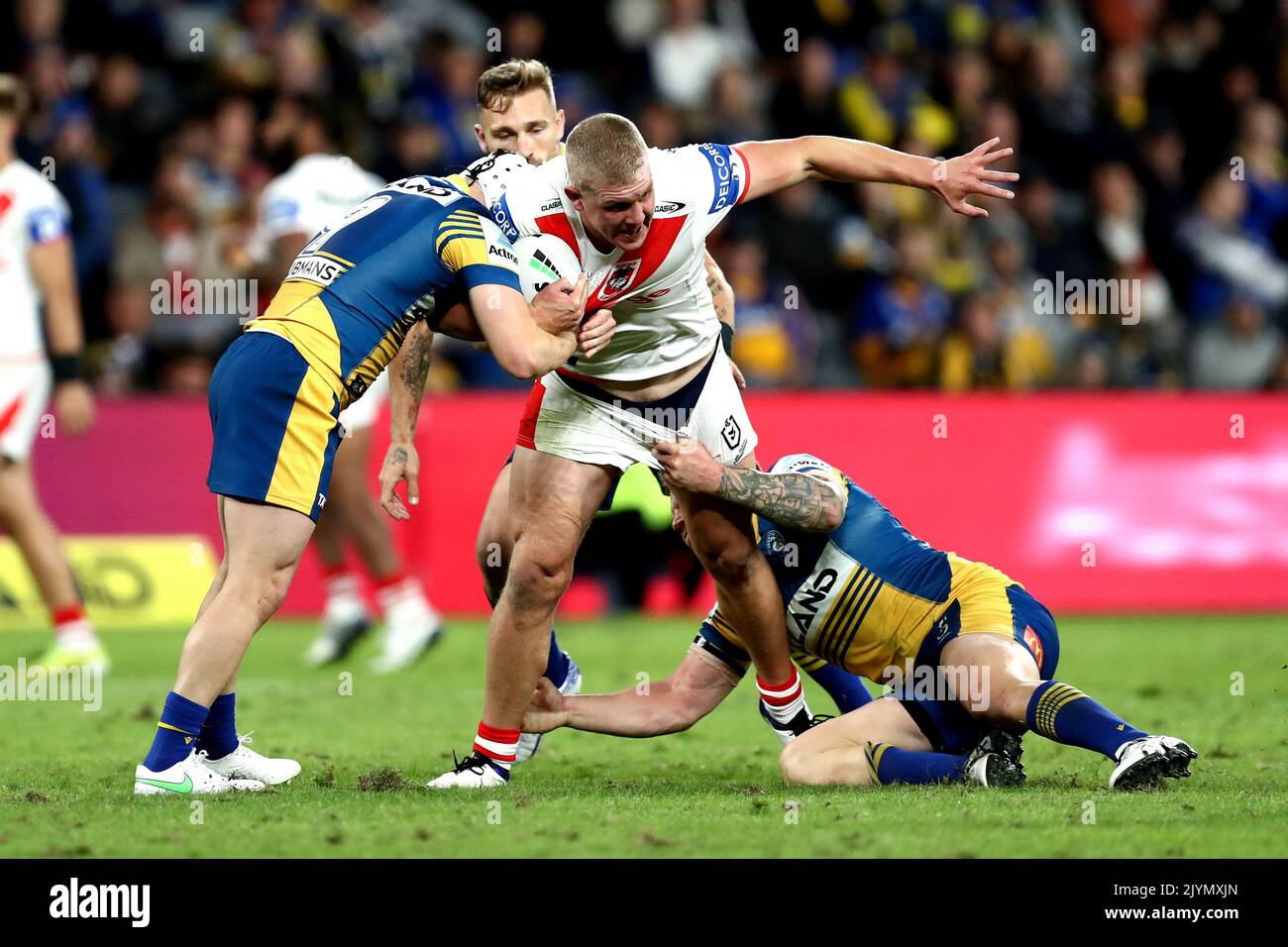 Daniel Alvaro of the Dragons is tackled by the Eels defence during the ...
